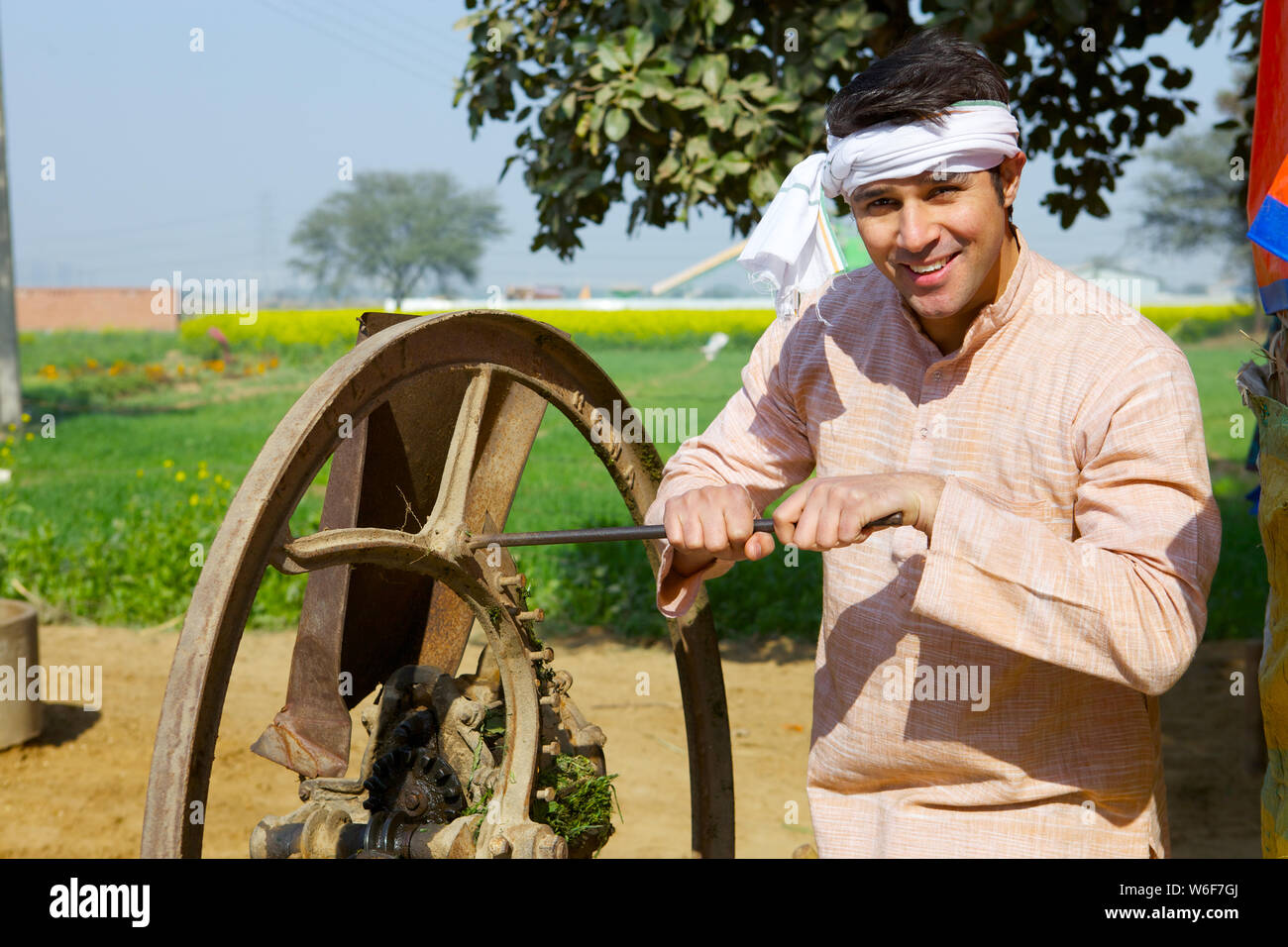 Farmer using fodder cutter Stock Photo - Alamy