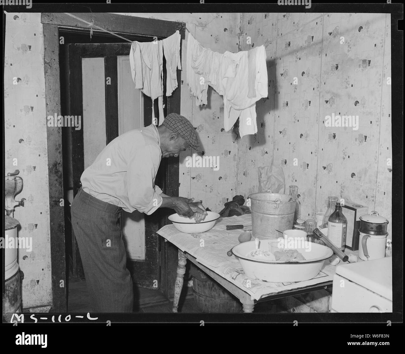 Amos Wilson, miner, washing hands in kitchen of his home. Koppers Coal ...