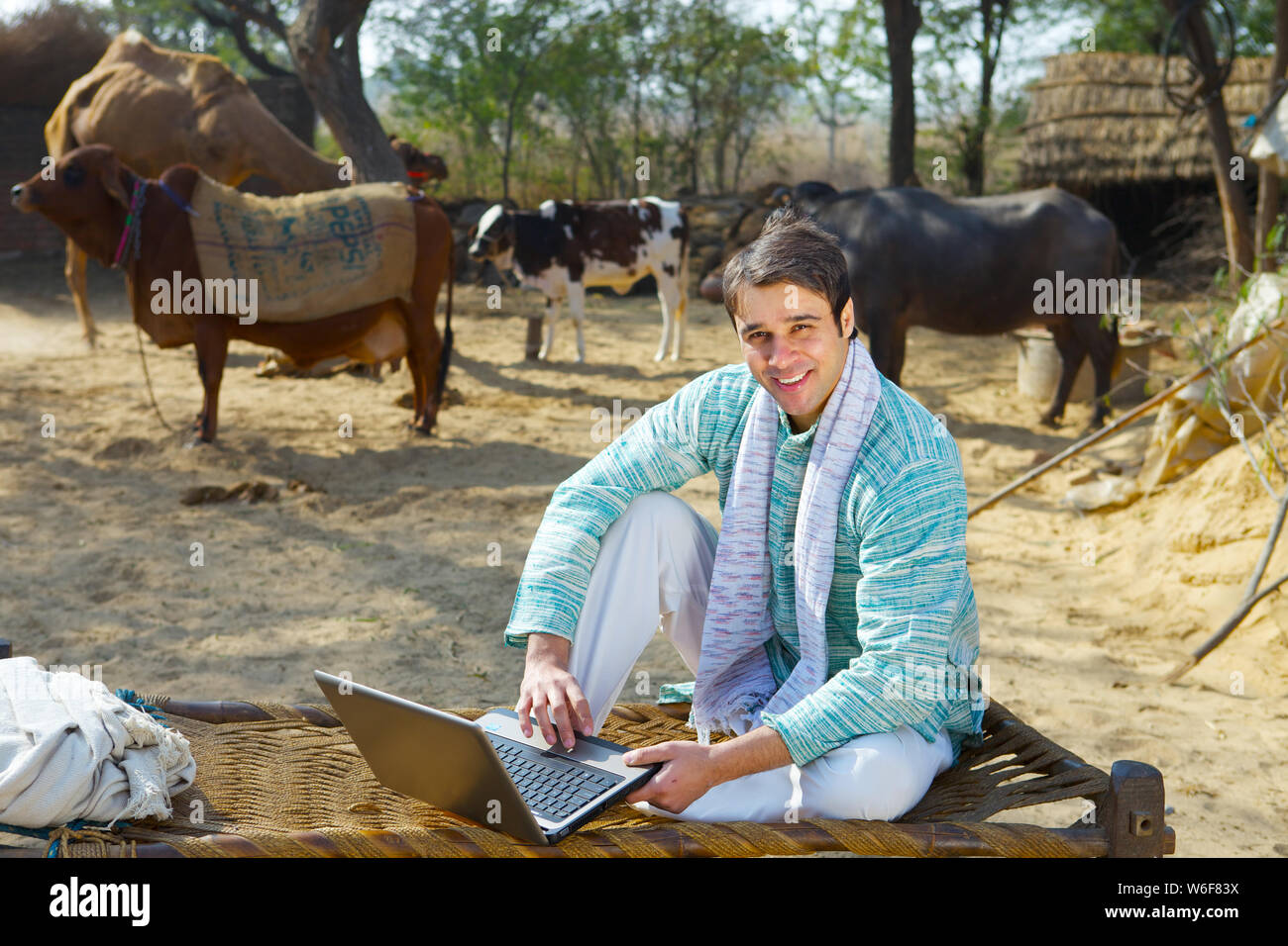 Farmer using a laptop Stock Photo - Alamy
