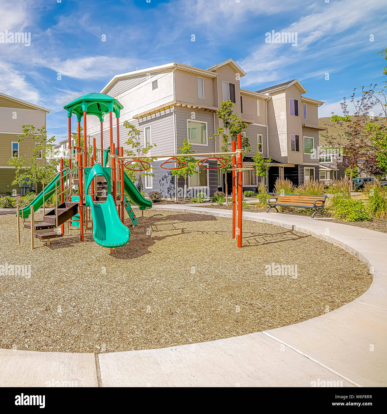 Square frame Playground surrounded by a circular pathway and benches ...