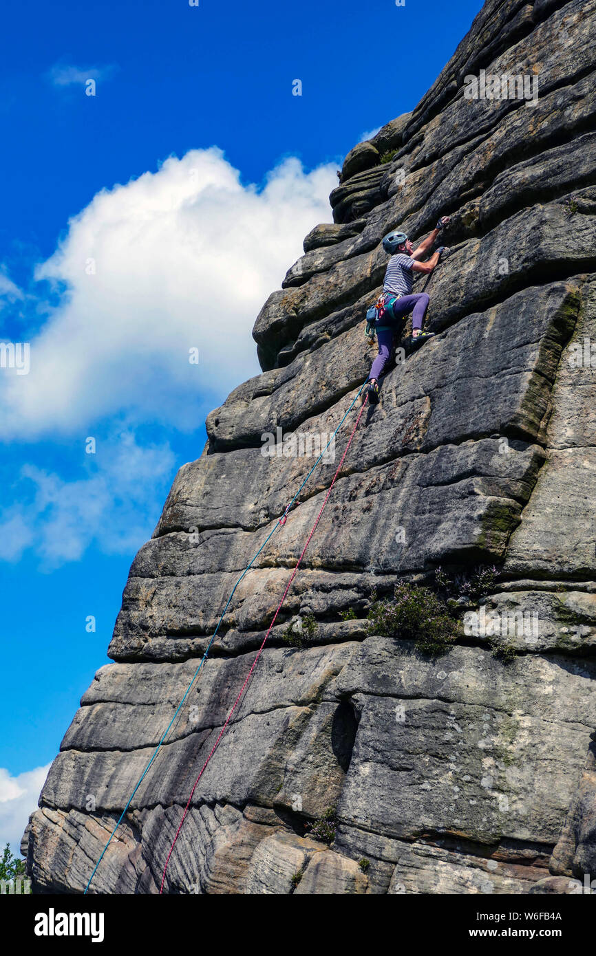 Rock climbers on Stanage Edge, Gritstone, Peak District, National Park ...