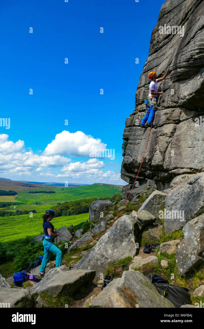 Rock climbers on Stanage Edge, Gritstone, Peak District, National Park ...