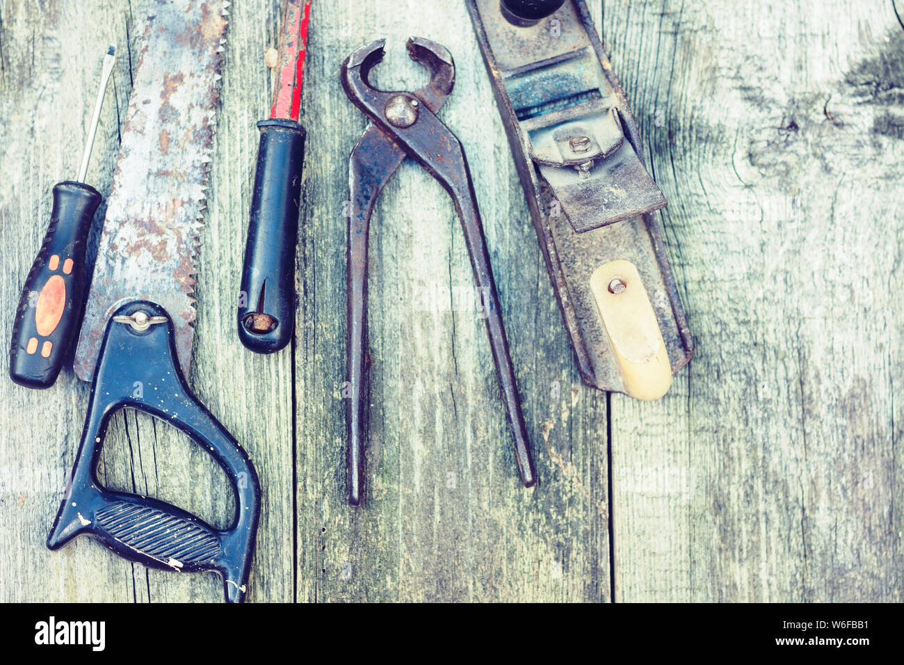 Set of vintage hand construction tools hammers with nails on a wooden ...