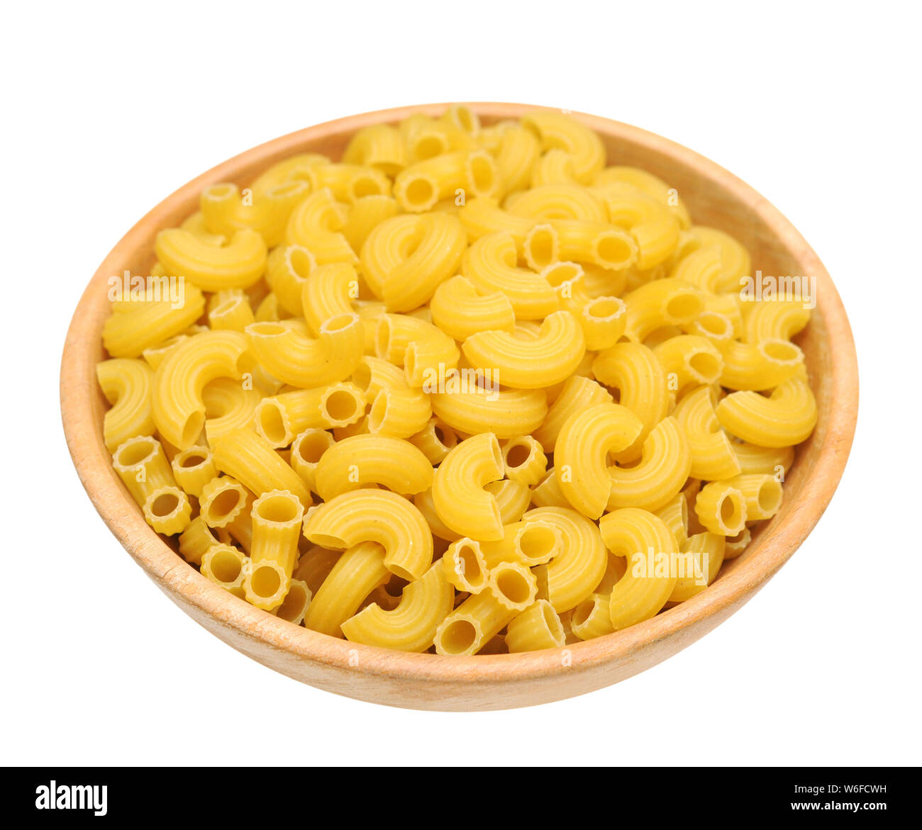 tube pasta in wooden bowl isolated on white background Stock Photo - Alamy