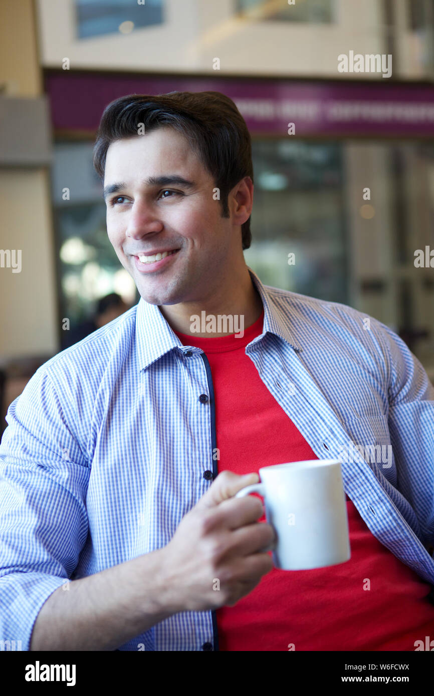 Man having a cup of coffee in a cafe Stock Photo - Alamy