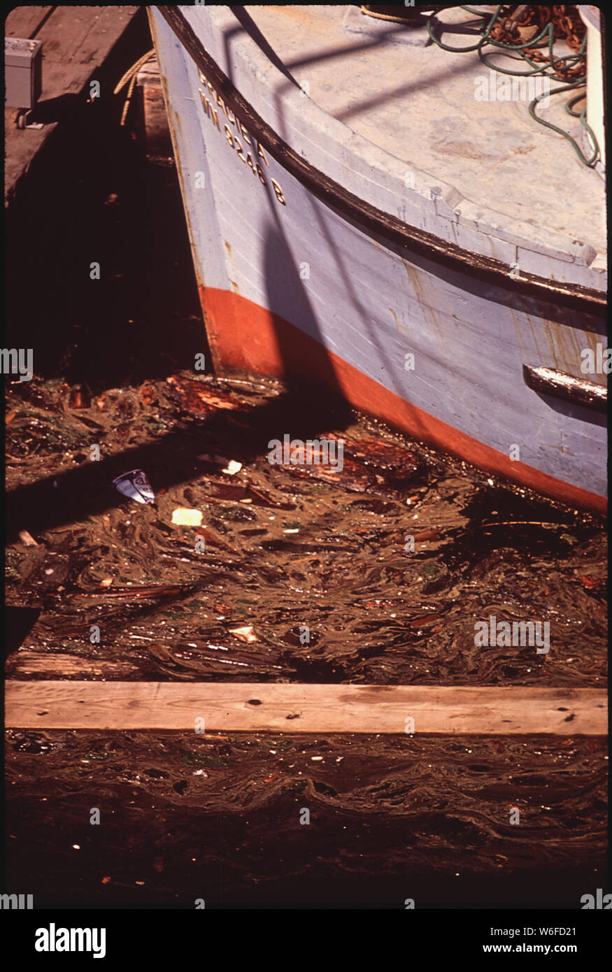BOW OF FISHING BOAT IN POLLUTED HARBOR Stock Photo - Alamy