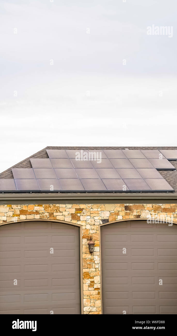Vertical Solar panels installed on the garage roof of a home with ...