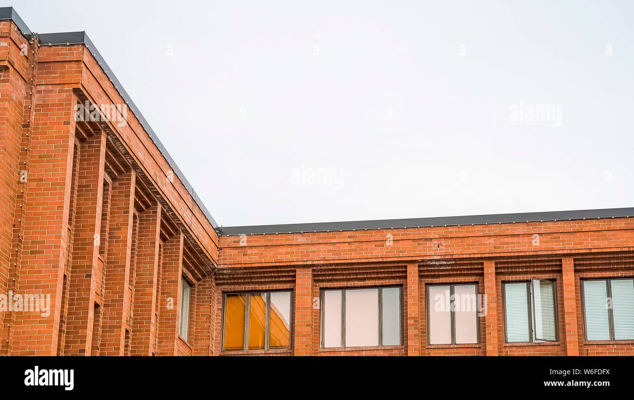 Panorama Exterior of red brick building with flat rooftop and shiny ...