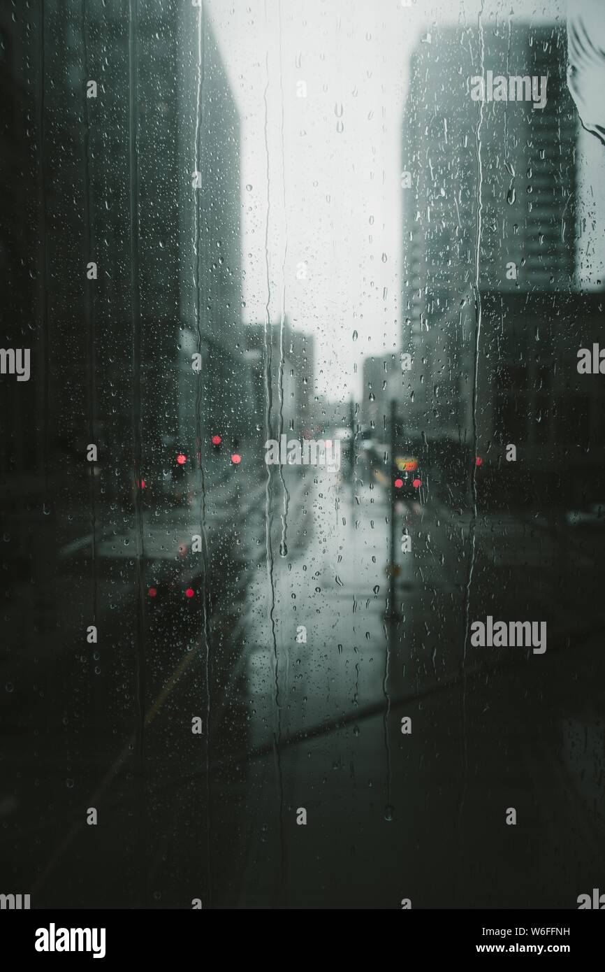 Vertical shot of raindrops pouring down a glass window Stock Photo - Alamy