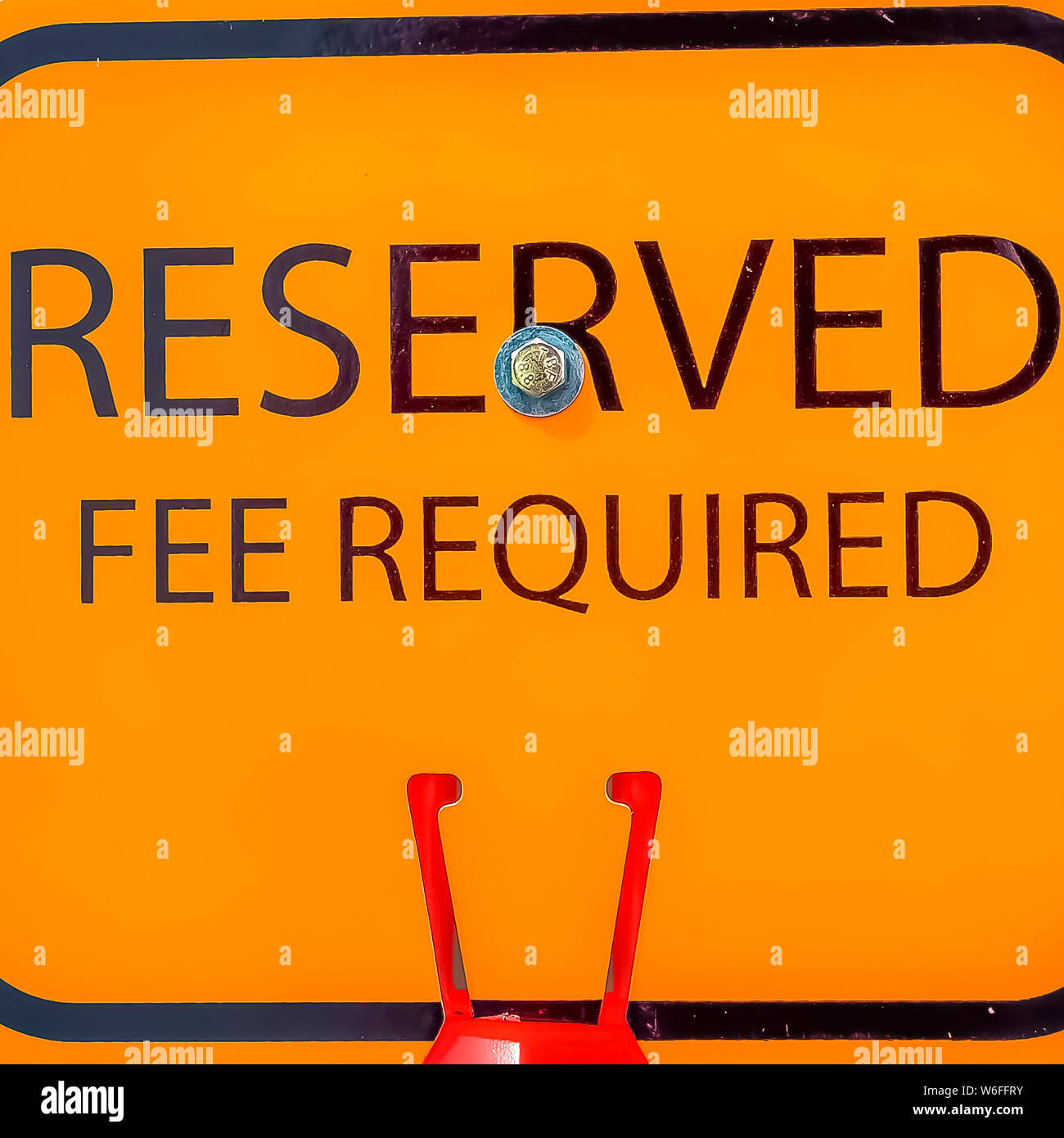 Square Close up of an orange Reserved sign with tables and benches in ...