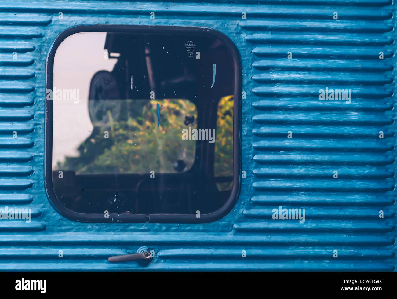 Glass window of old vintage train with blue container abstract travel ...