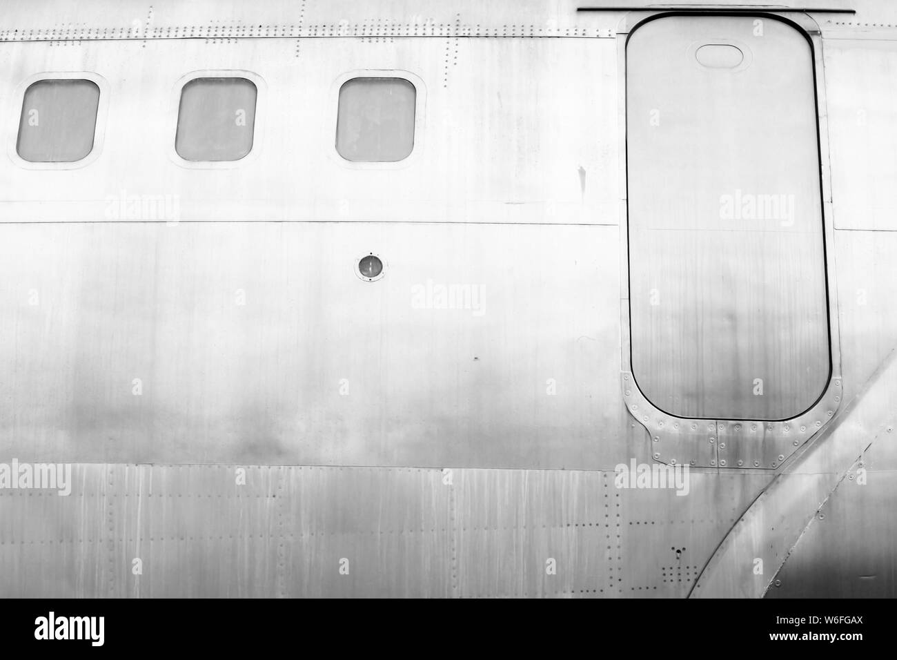 Windows of the white metal surface airplane with emergency exit ...
