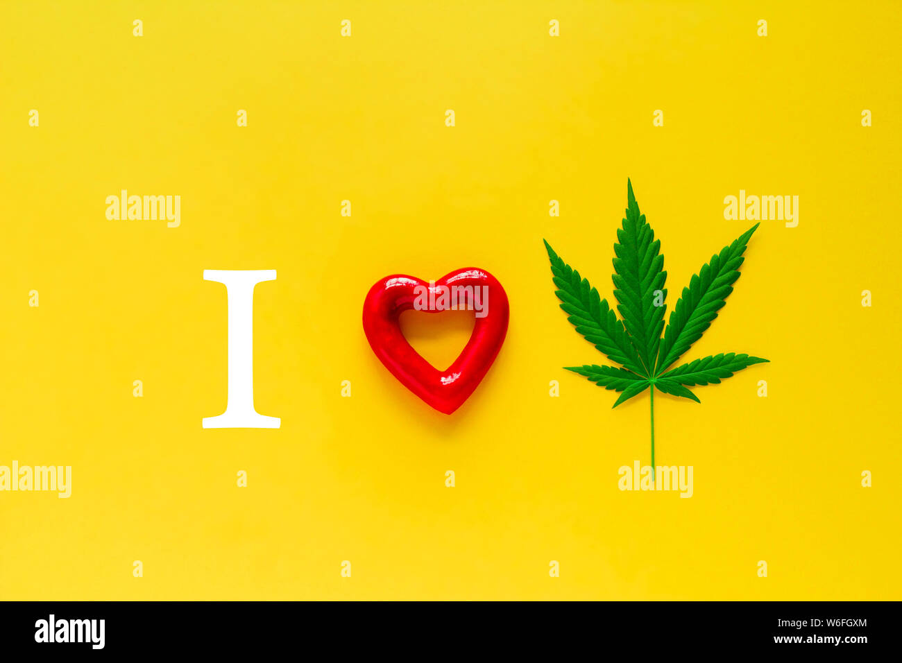 marijuana and red heart on a yellow background, i love marijuana concept Stock Photo - Alamy