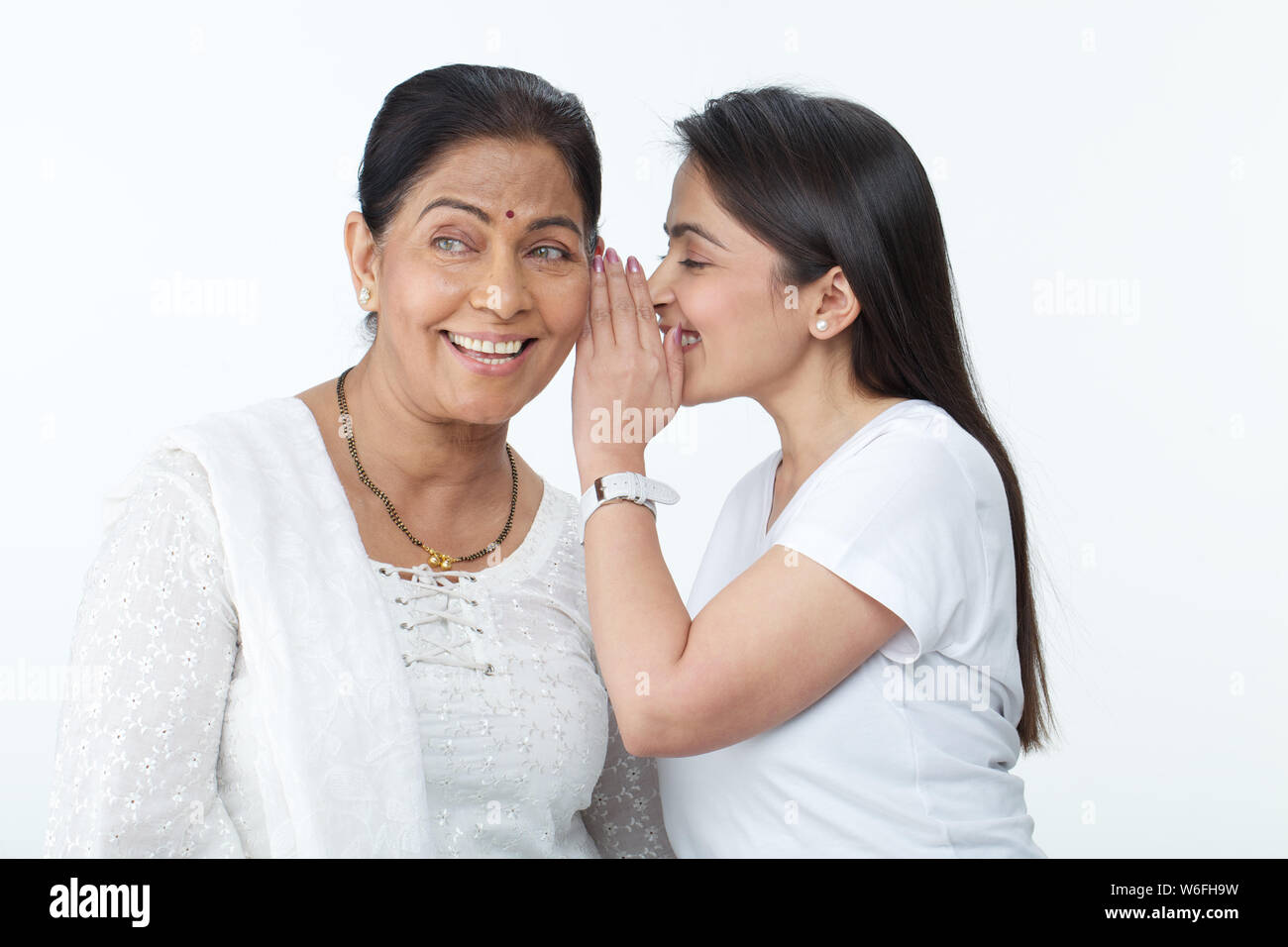 Teenage girl whispering into her mother ears Stock Photo - Alamy