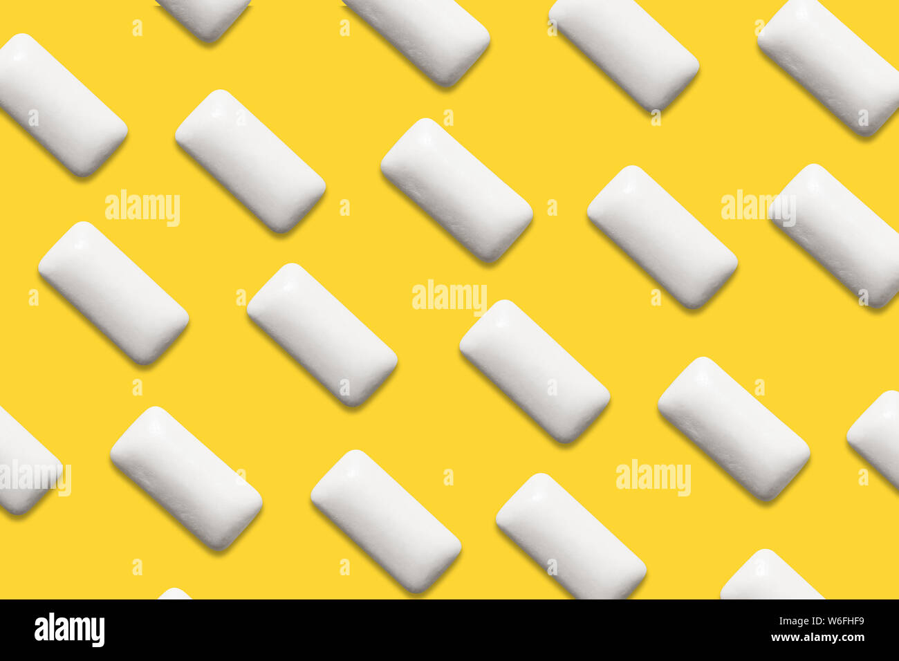 White chewing gum pattern on yellow background Stock Photo - Alamy