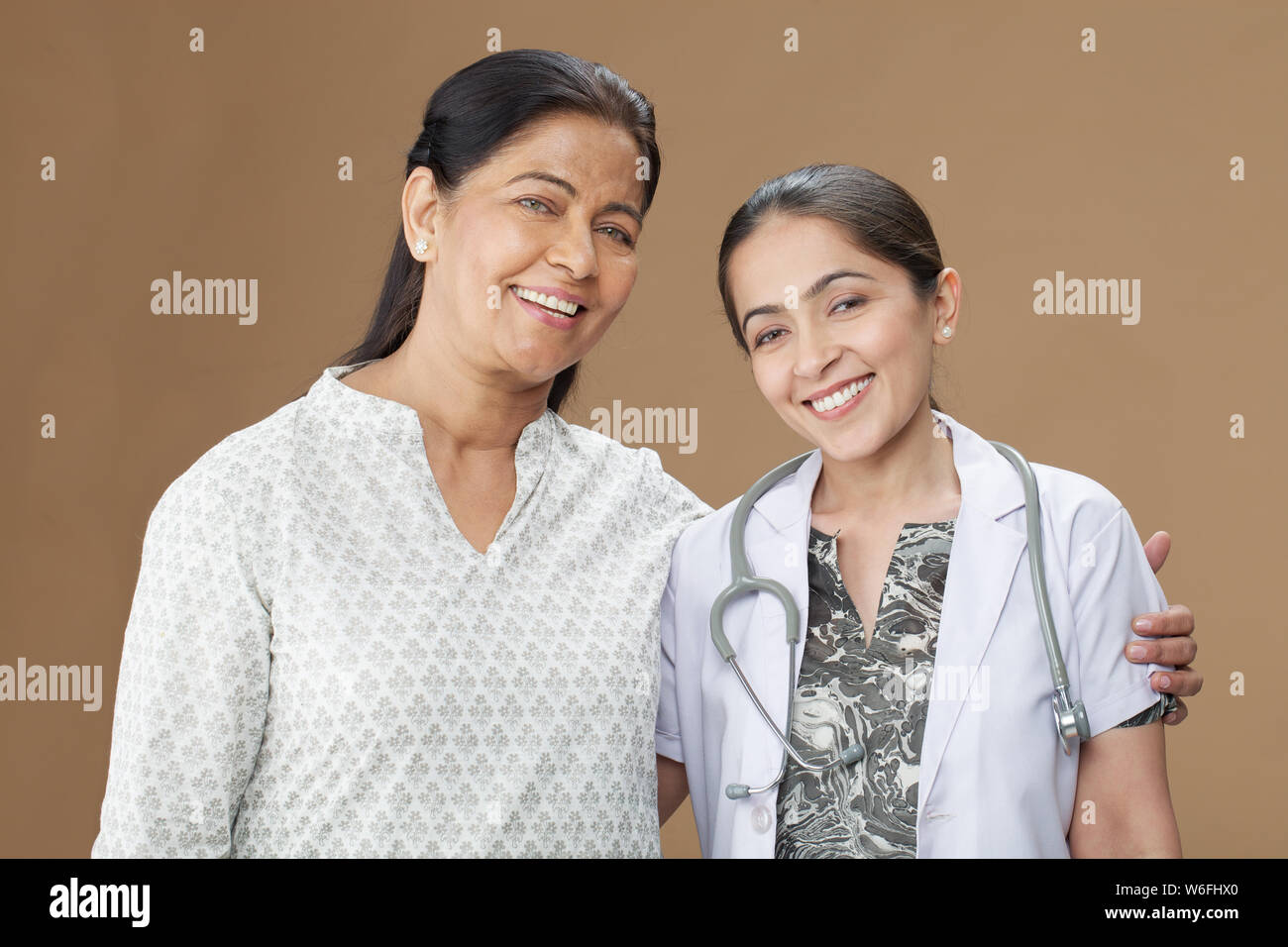 Female doctor smiling with her mother Stock Photo - Alamy