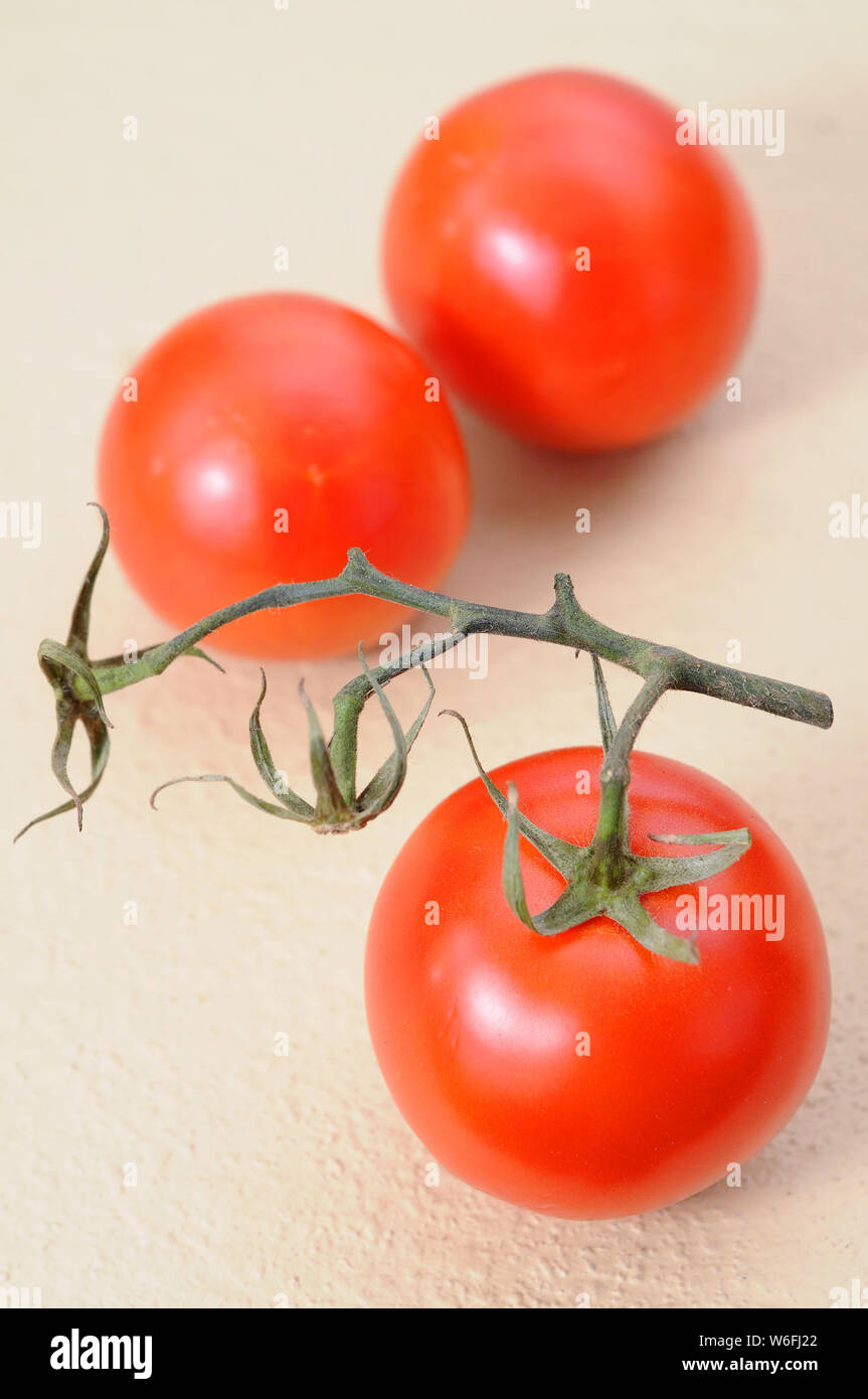 Three tomatoes on rustic hi-res stock photography and images - Alamy