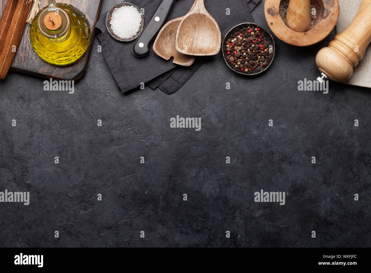 Cooking utensils and spices on stone kitchen table. Top view with copy ...