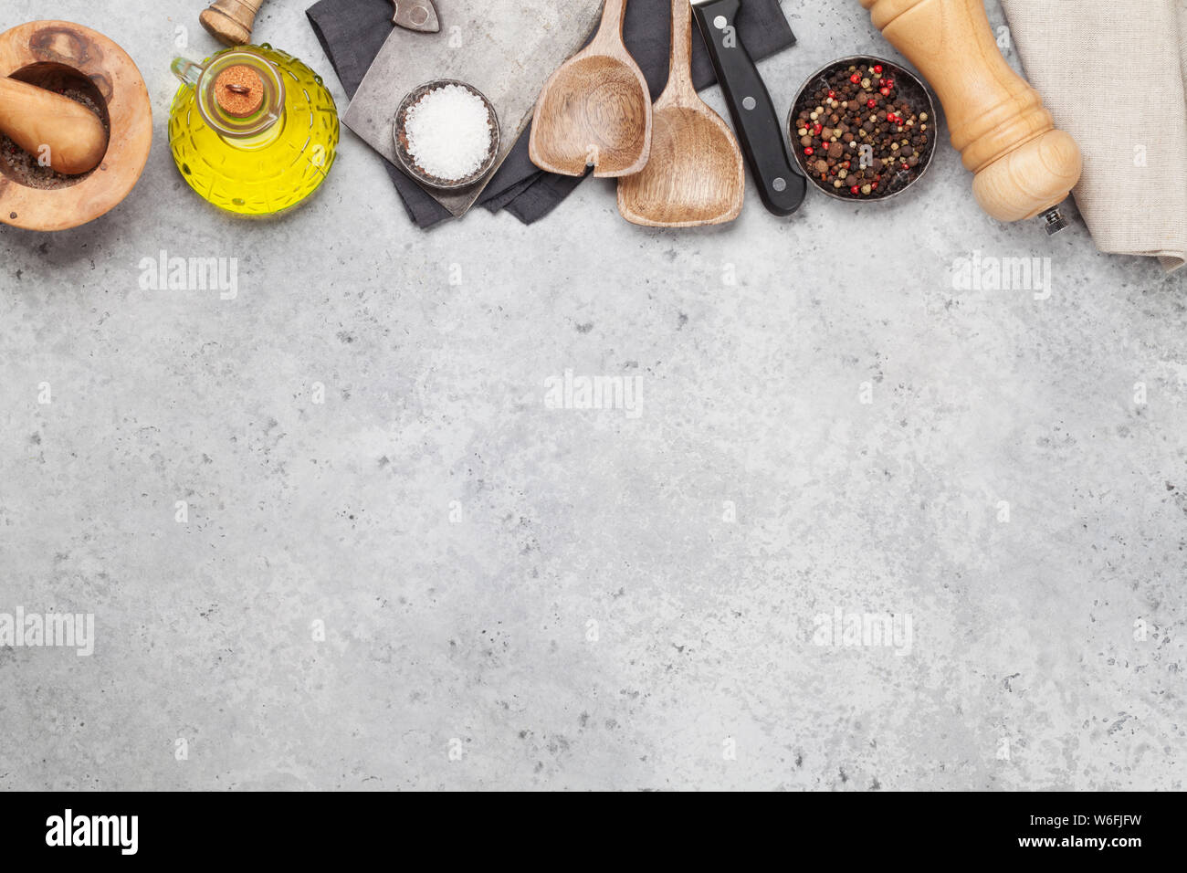 Cooking utensils and spices on stone kitchen table. Top view with copy ...