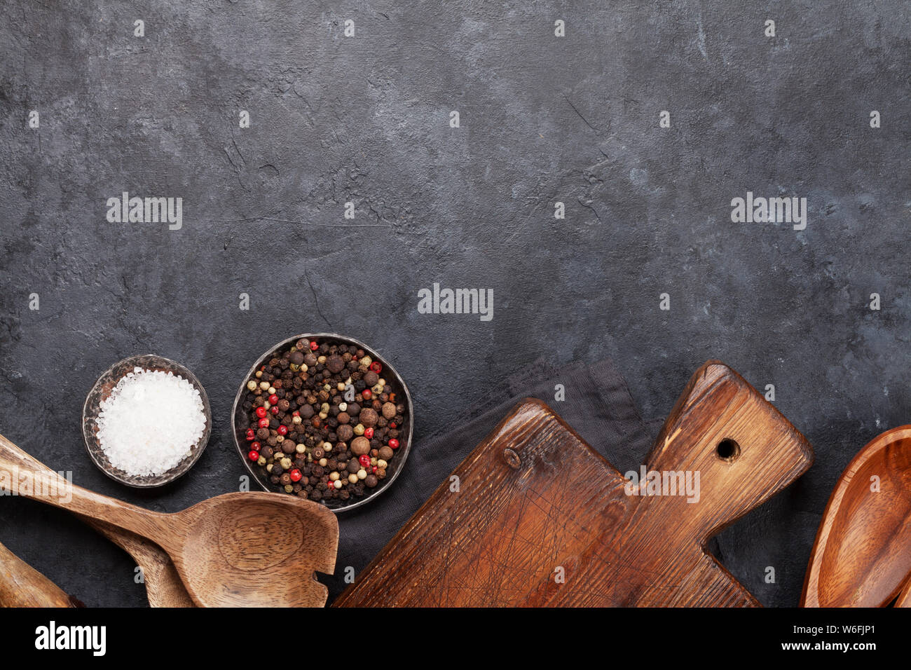 Cooking utensils and spices on stone kitchen table. Top view with copy ...