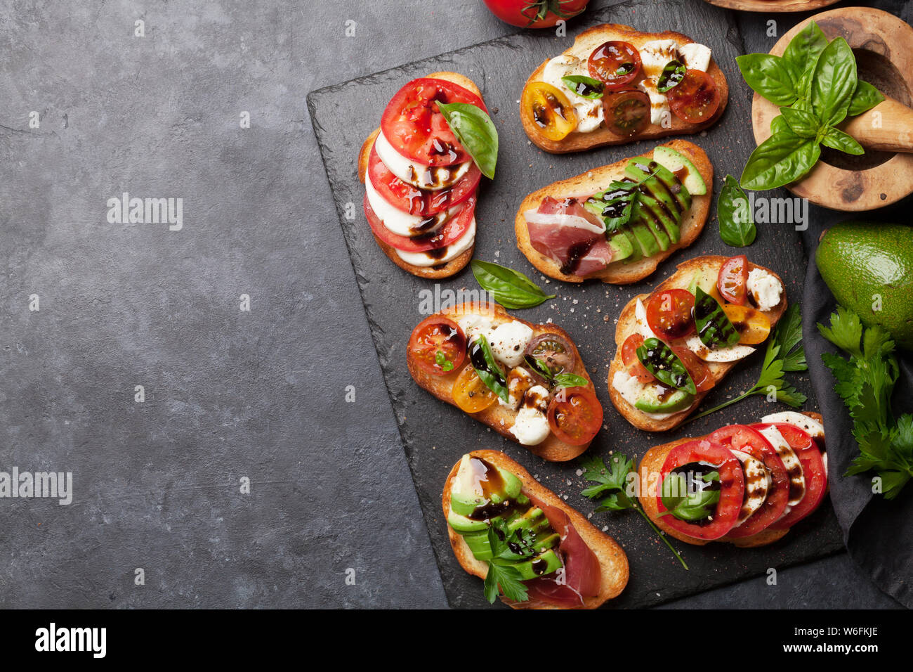 Traditional spanish tapas with tomatoes, mozzarella cheese, avocado and ...