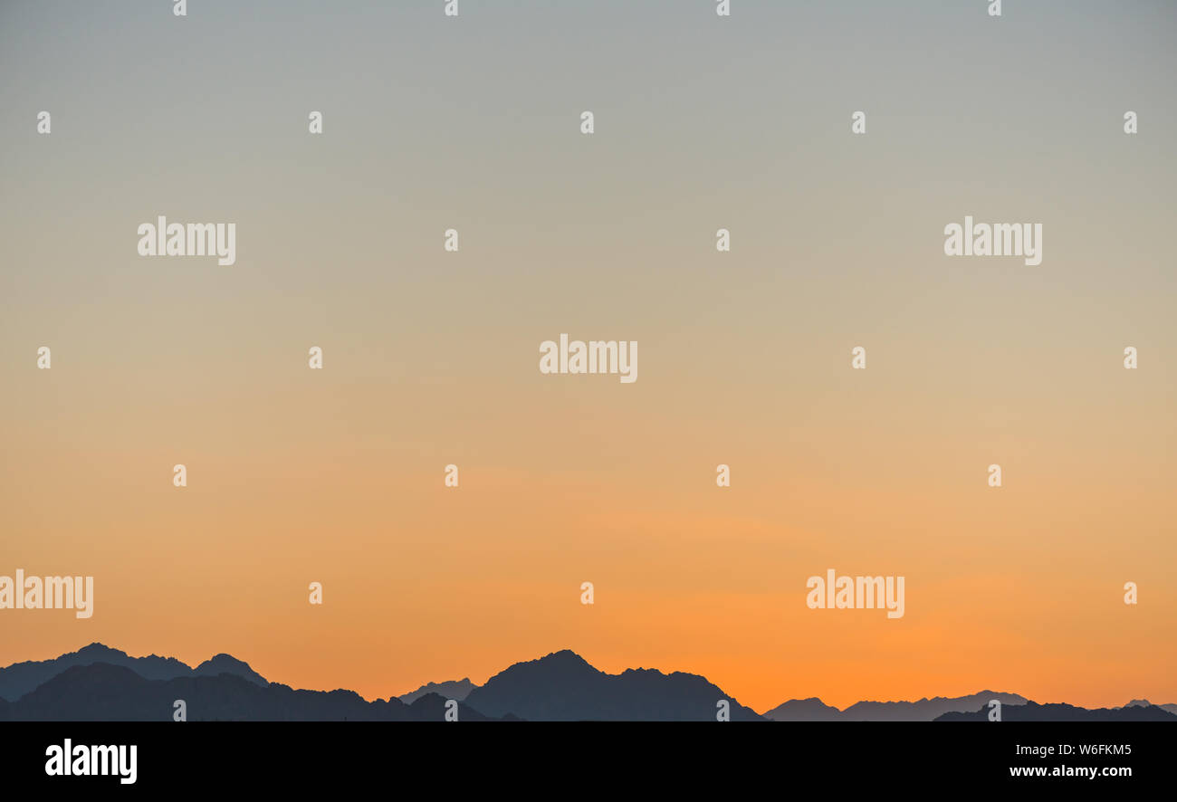 horizon line over mountains at summer sunset Stock Photo - Alamy