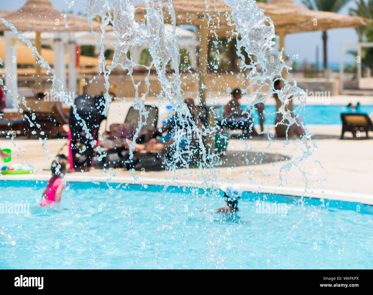 splashing water surface at sunny pool activities background Stock Photo ...