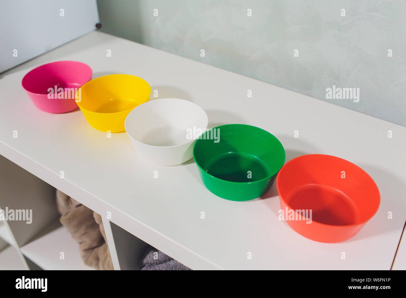 reusable colored plastic dishes on the shelf in the store Stock Photo ...