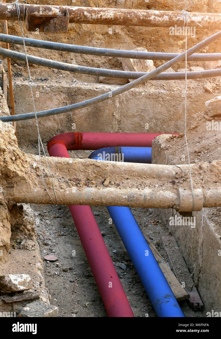 blue and red water pipe in the ground Stock Photo - Alamy