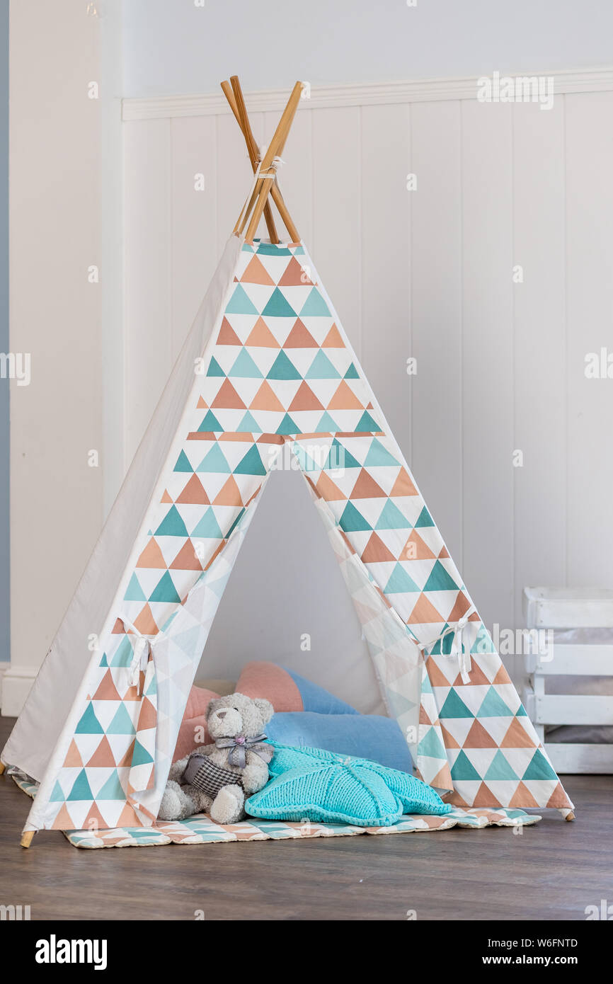 Decorative boho styled cozy hut with decor. Wigwam in room ...