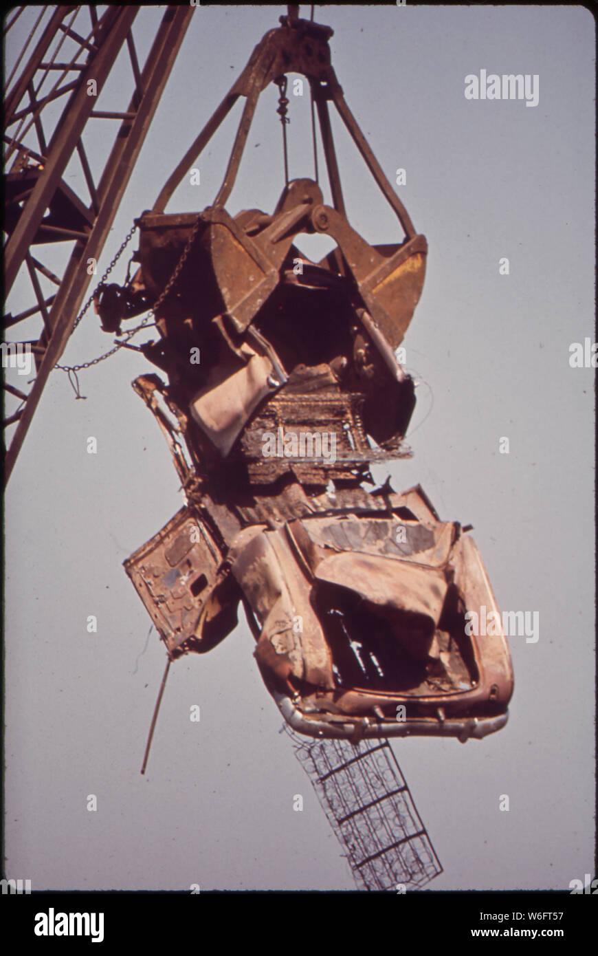 CRANE ABOUT TO DROP SKELETON OF CAR INTO AUTOMOBILE GRAVEYARD IN ...