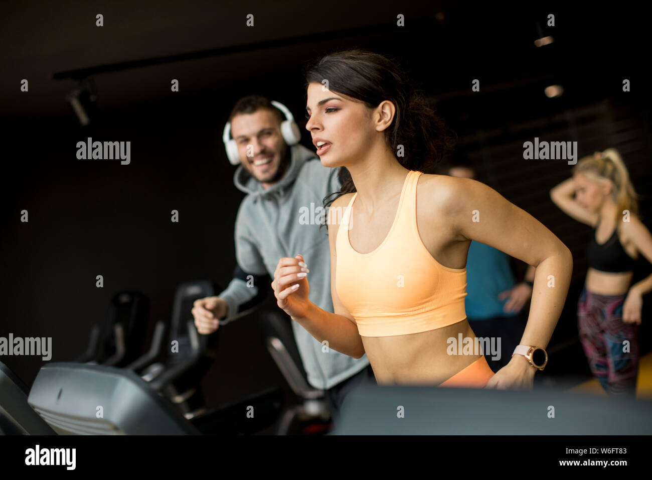 Group of young people using threadmill in modern gym Stock Photo - Alamy