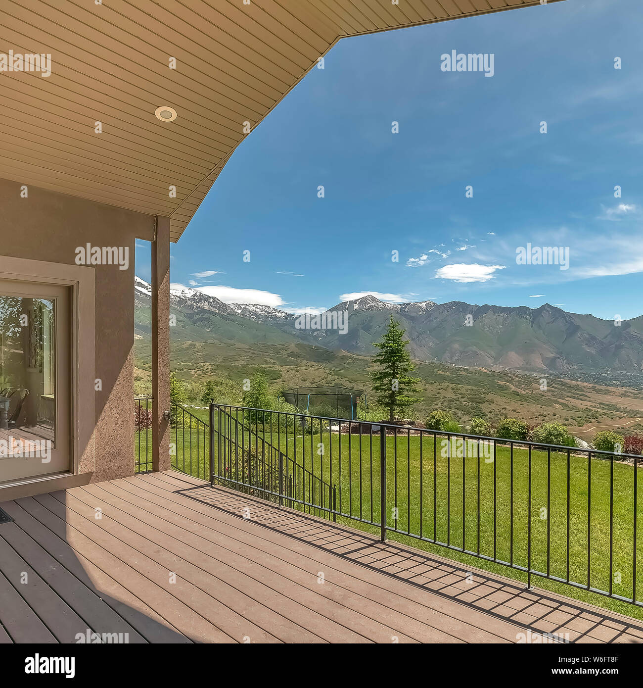 Square Balcony of a home with metal ailing and stairs that leads to the ...