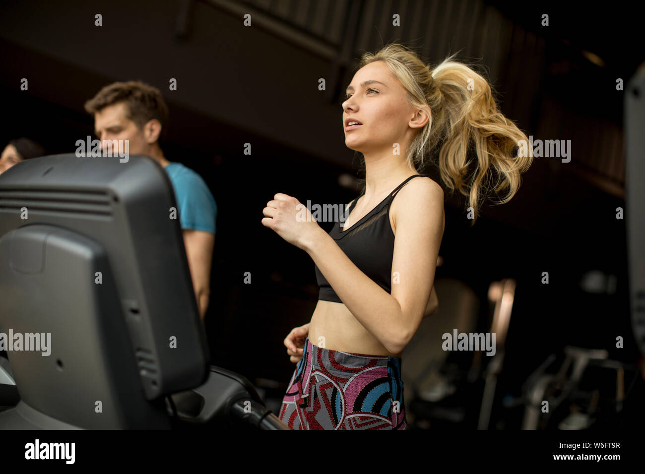 Group of young people using threadmill in modern gym Stock Photo - Alamy
