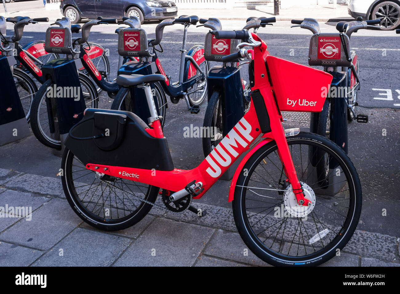 Uber Jump red e-bike left next to Santander Cycles, London, England, U ...