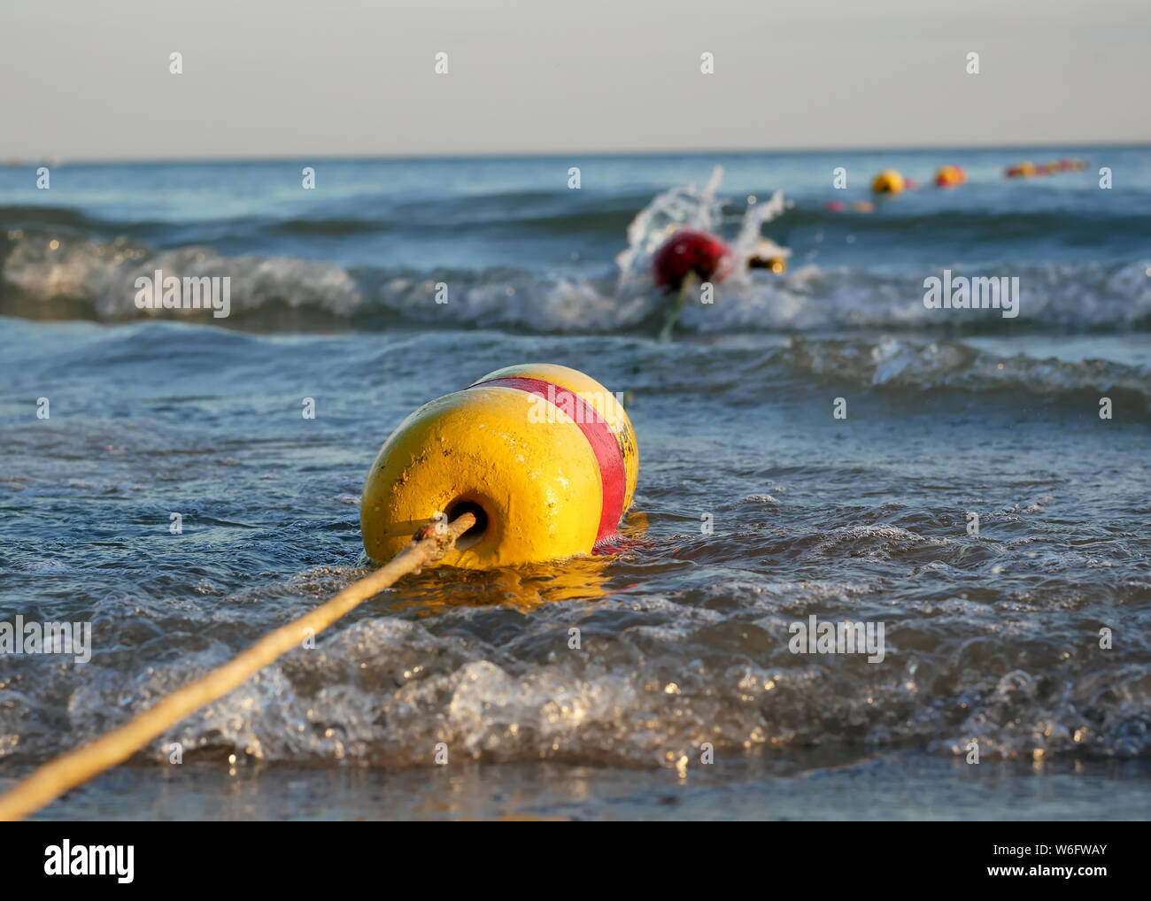 colorful enclosing buoys on the sea Stock Photo - Alamy