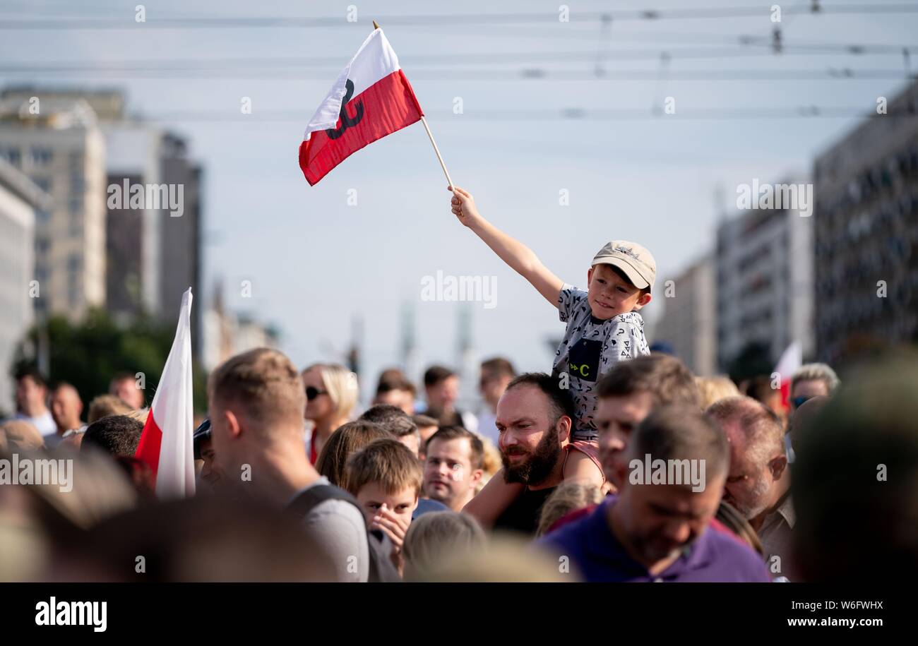 Warsaw, Poland. 01st Aug, 2019. Poles with flags take part in a ...