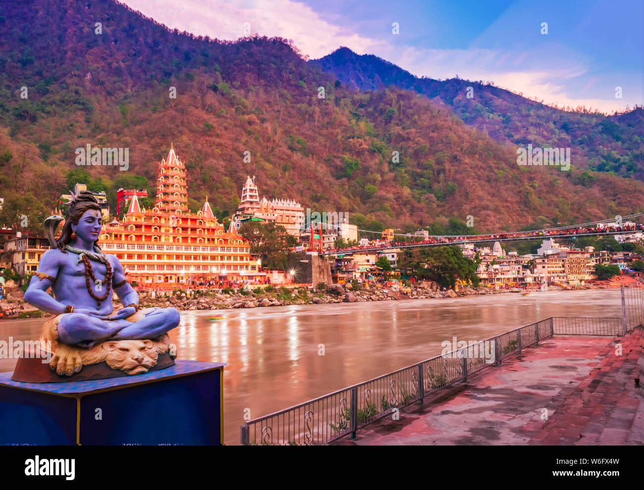 River Ganges, the famous bridge Laxman Jhula surrounded by temples and ...