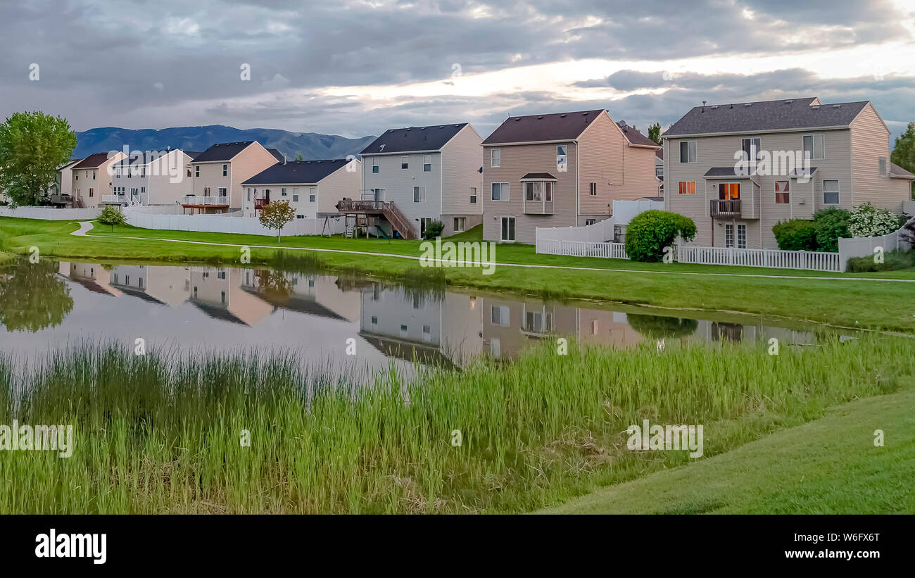 Panorama Shiny pond with bridge on a grassy park in front of lovely ...