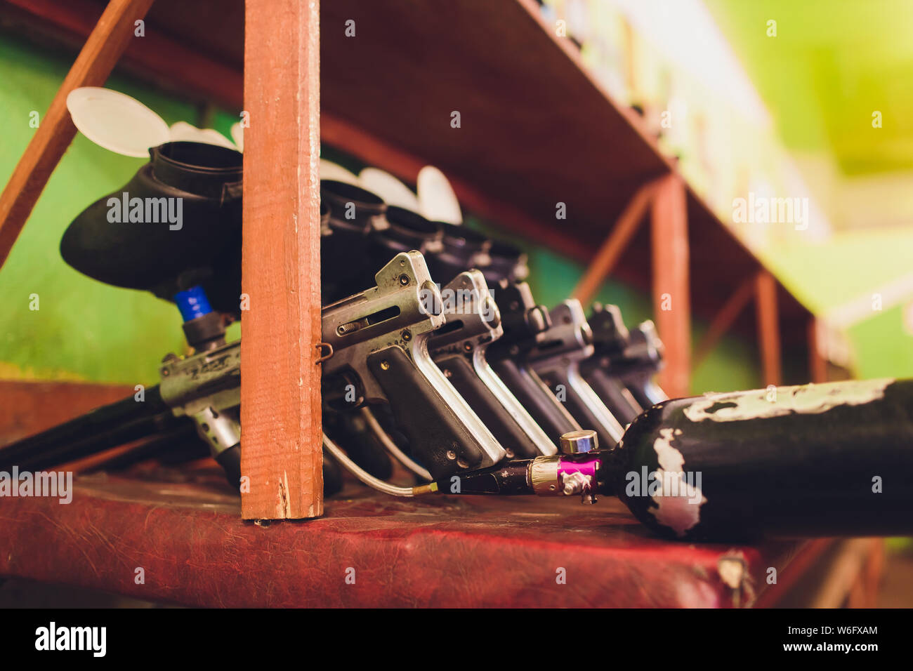 Paintball guns on a wooden table. play paintball Stock Photo - Alamy