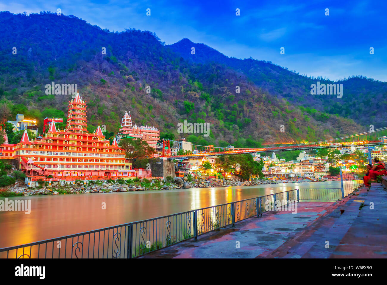 River Ganges, the famous bridge Laxman Jhula surrounded by temples and ...