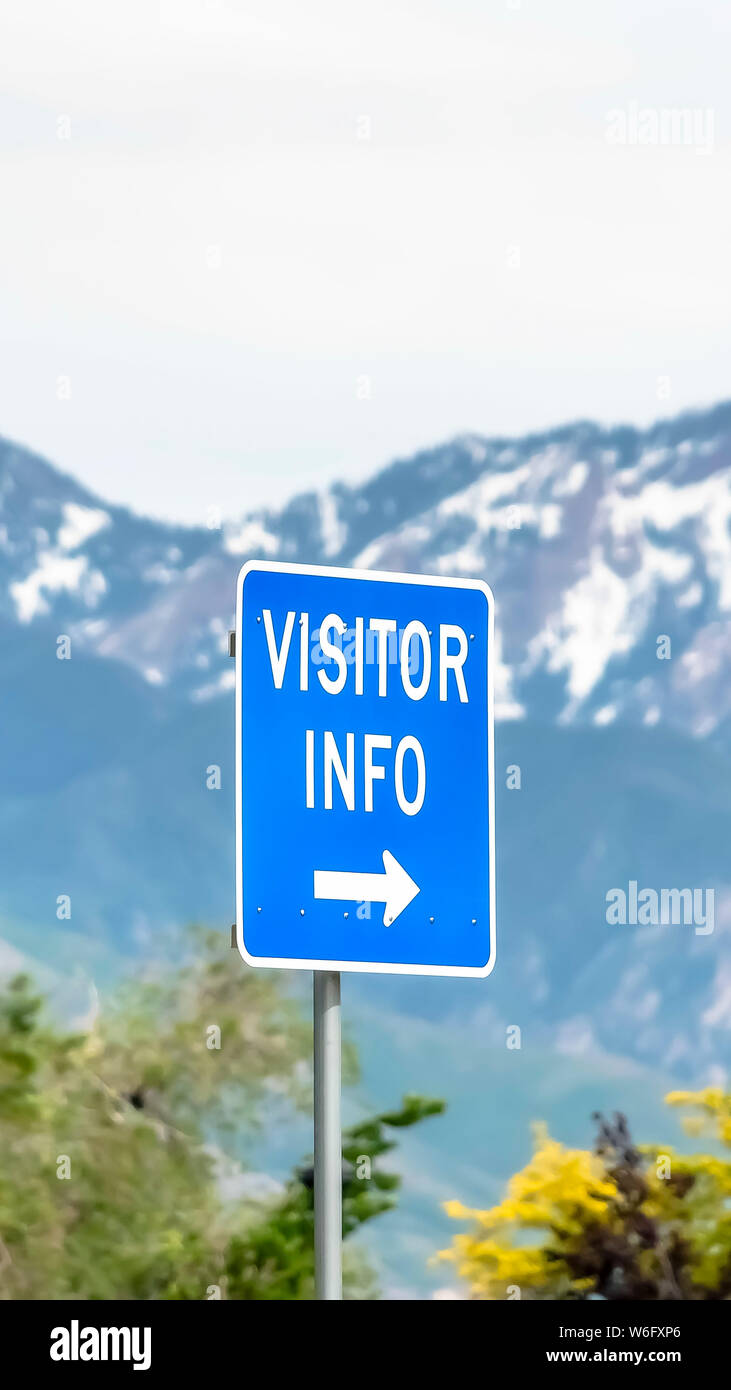 Vertical frame Close up of a Visitor Info sign with trees snowy ...