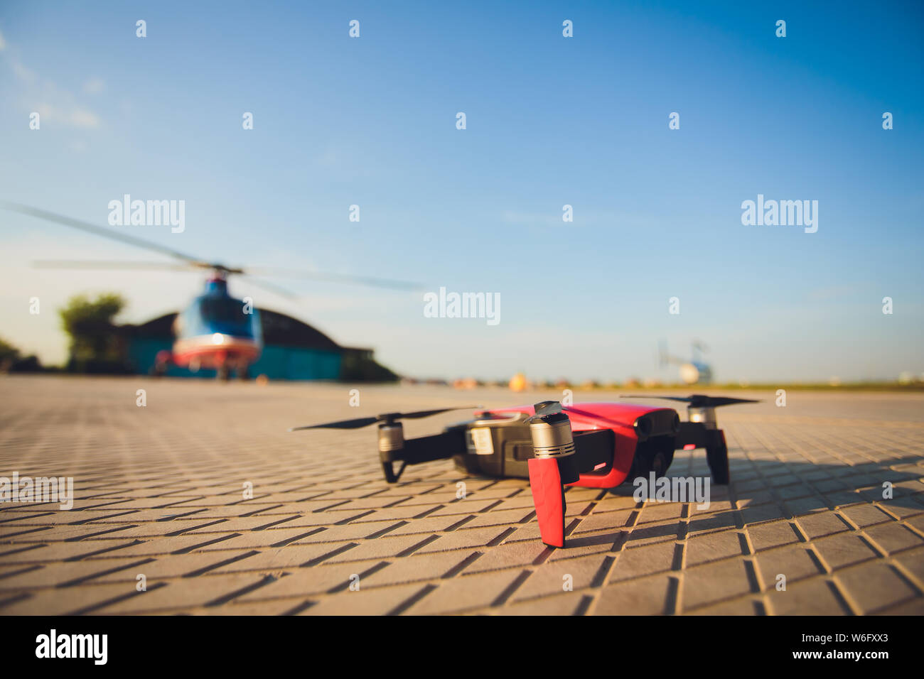 Drone taking off on the background of a helicopter Stock Photo - Alamy