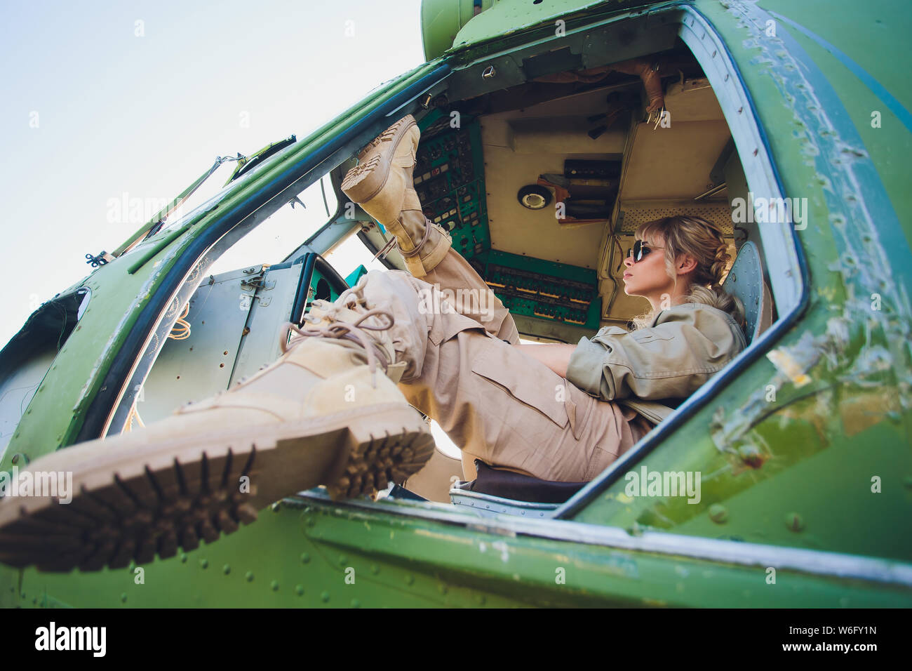 Female pilot in cockpit of helicopter before take off. Young woman helicopter pilot Stock Photo ...