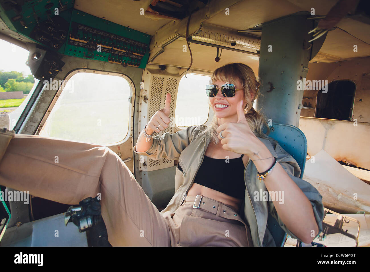 Female pilot in cockpit of helicopter before take off. Young woman helicopter pilot Stock Photo ...