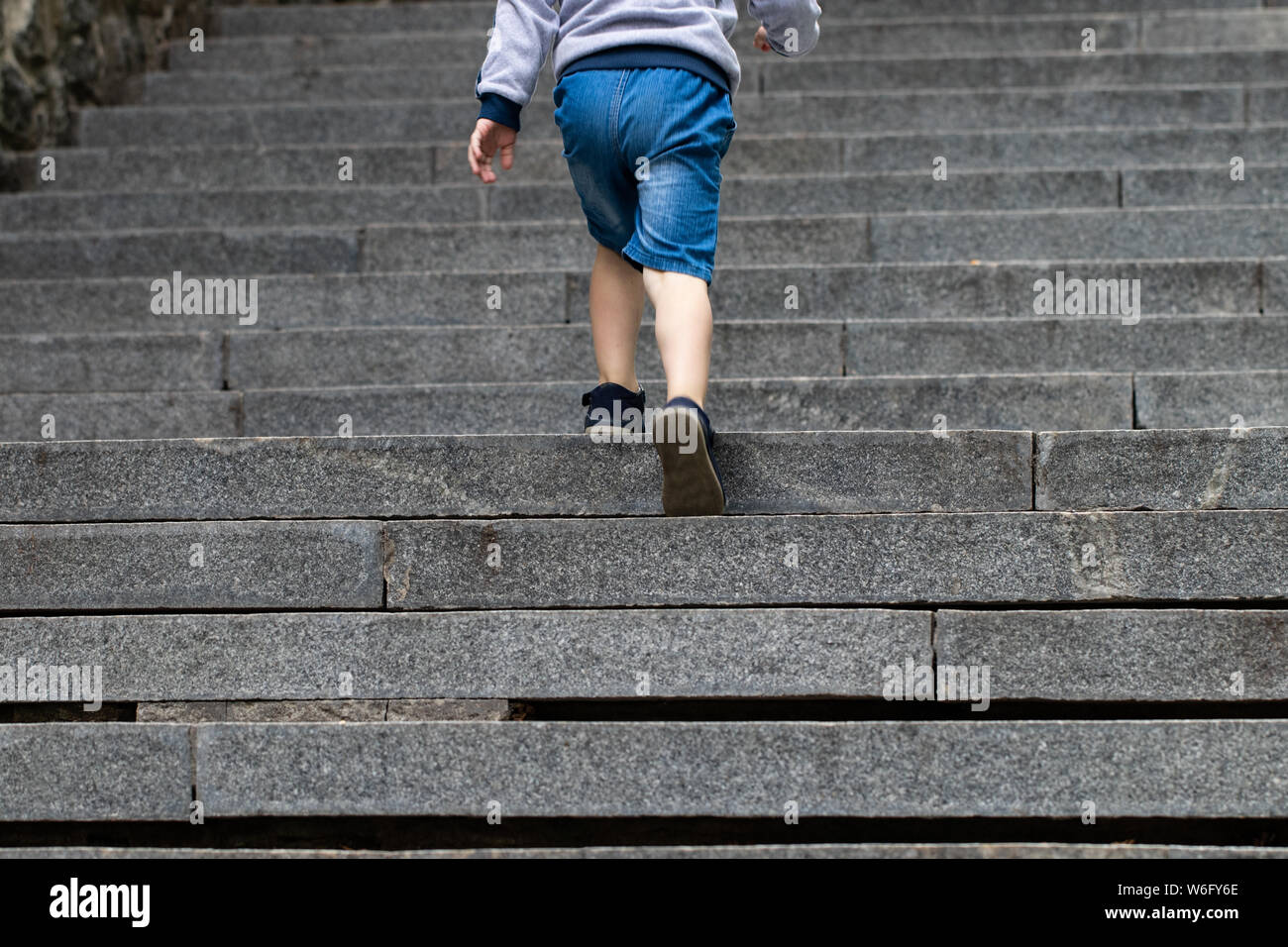 Boy climbing steps ladder hi-res stock photography and images - Alamy
