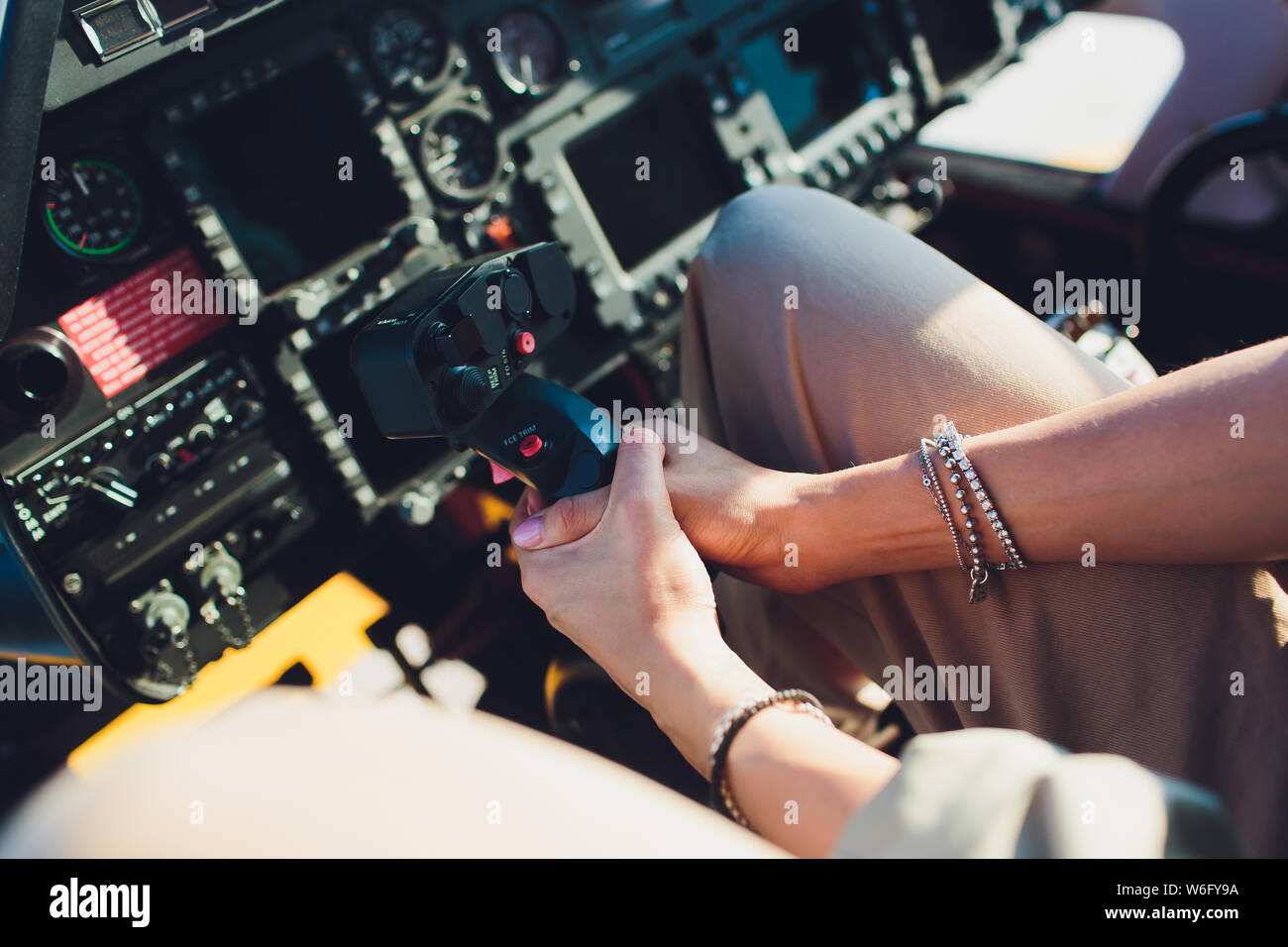 Female pilot in cockpit of helicopter before take off. Young woman helicopter pilot Stock Photo ...