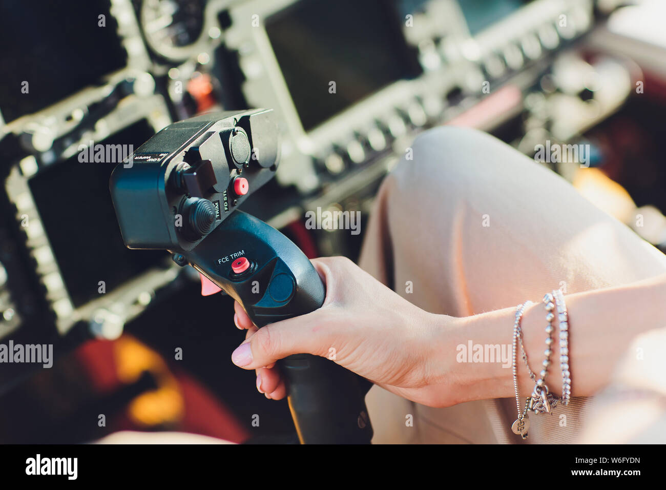 Female pilot in cockpit of helicopter before take off. Young woman ...