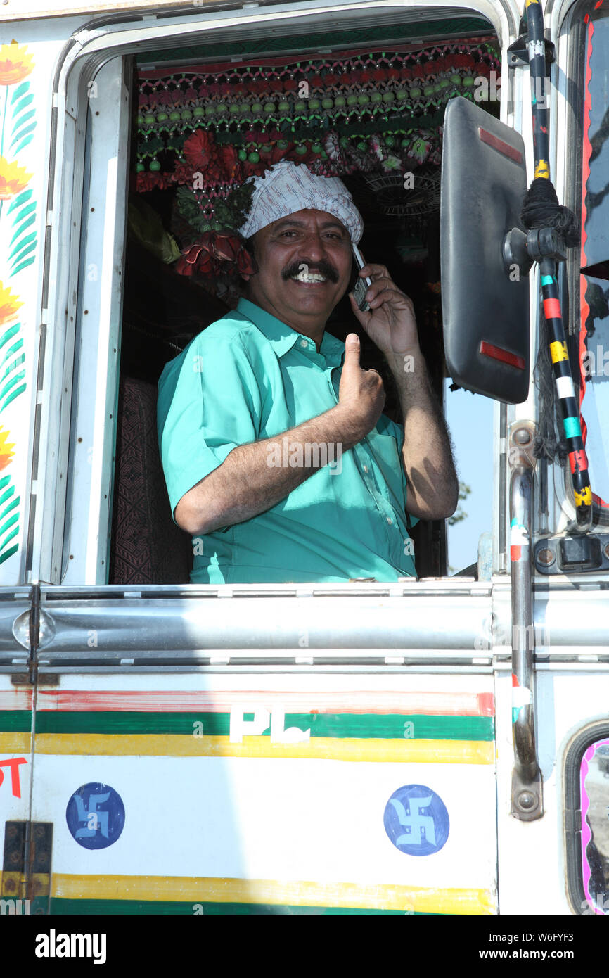 Truck driver talking on mobile phone Stock Photo - Alamy