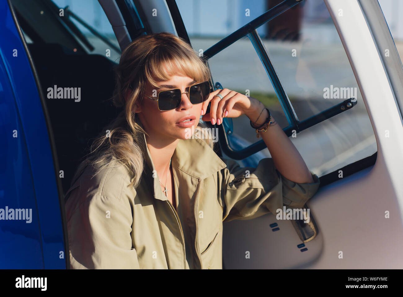 Female pilot in cockpit of helicopter before take off. Young woman helicopter pilot Stock Photo ...